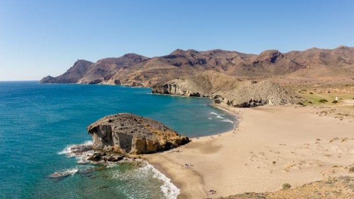 Police investigate after bloodied body is found on beach near popular ...