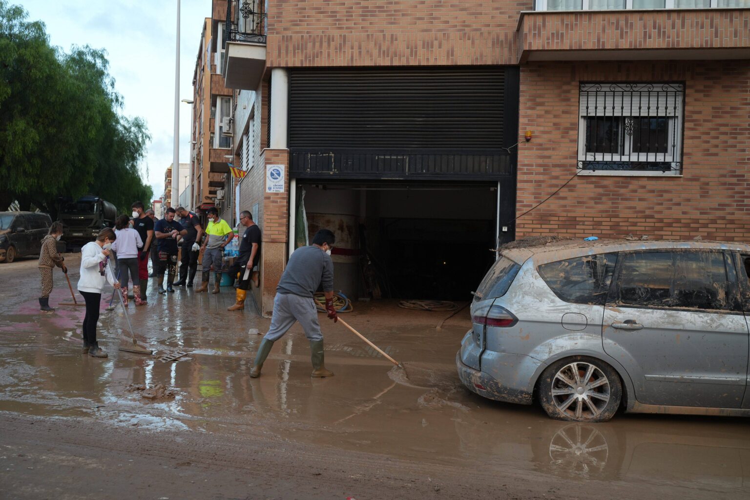 Watch: Moment woman is rescued from severe flooding in Malaga as locals ...